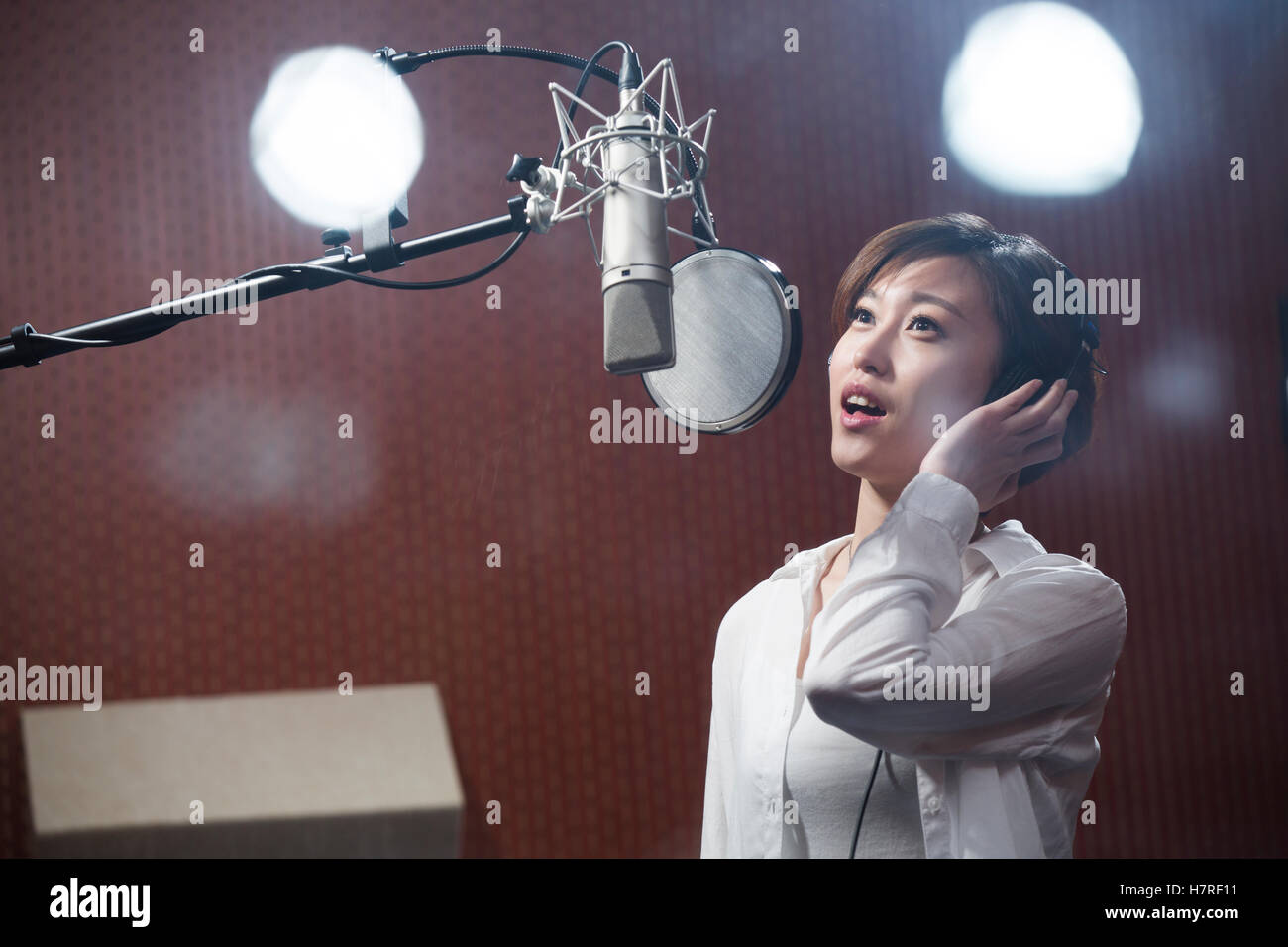 Young Chinese woman singing in recording studio Stock Photo - Alamy