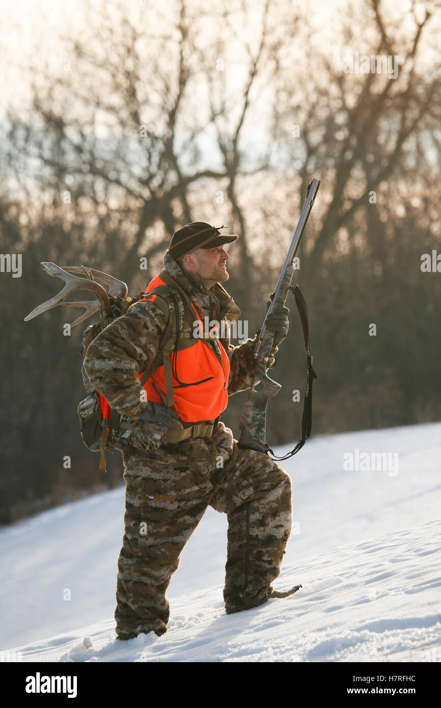 Hunter Walking Through Snow While Hunting For Whitetail Deer Stock ...