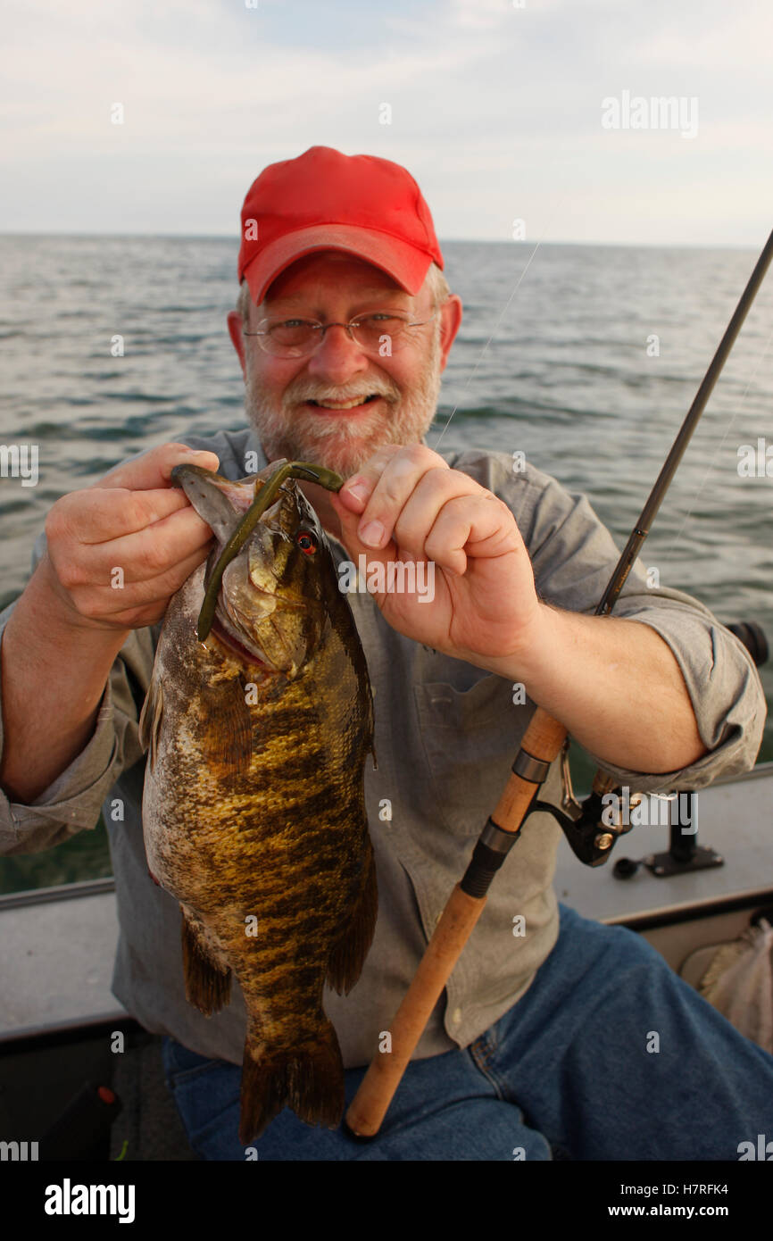 Fisherman unhooking fish hi-res stock photography and images - Alamy