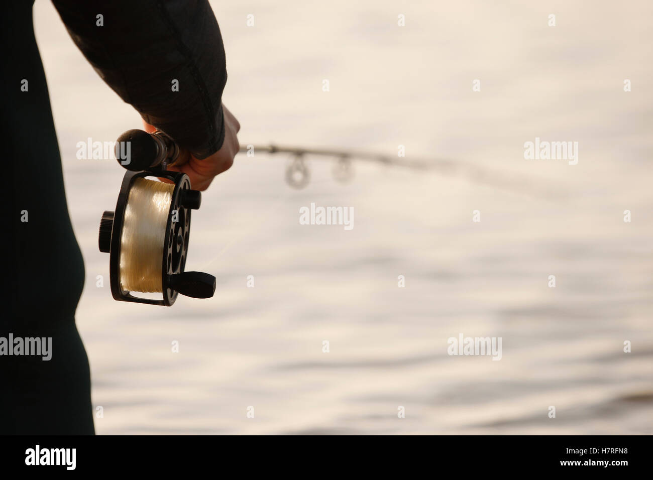 Fishermans hands hold fishing rod hi-res stock photography and images ...