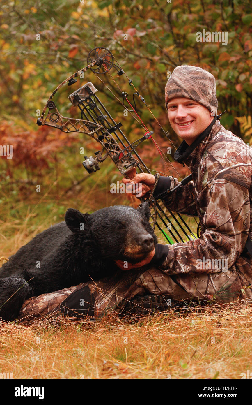Bear Hunter With Dead Bear Stock Photo - Alamy