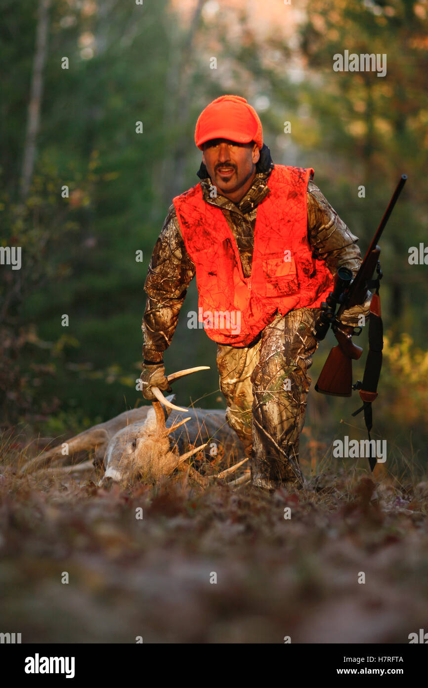 Whitetail Deer Hunter Drags Deer Out Of Field Stock Photo - Alamy