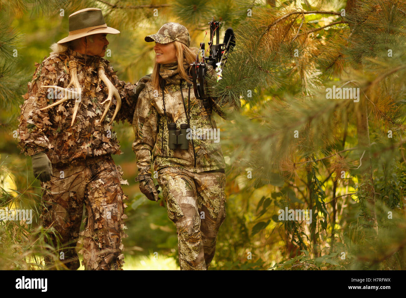 Male And Female Whitetail Hunters Walking In Woods Stock Photo - Alamy