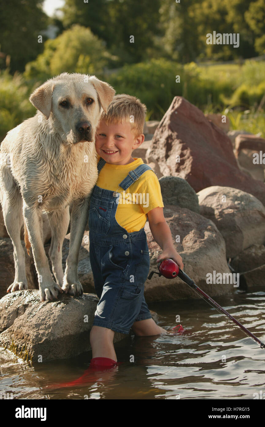 Young Boy And Yellow Lab Fishing In The Midwest Stock Photo - Alamy
