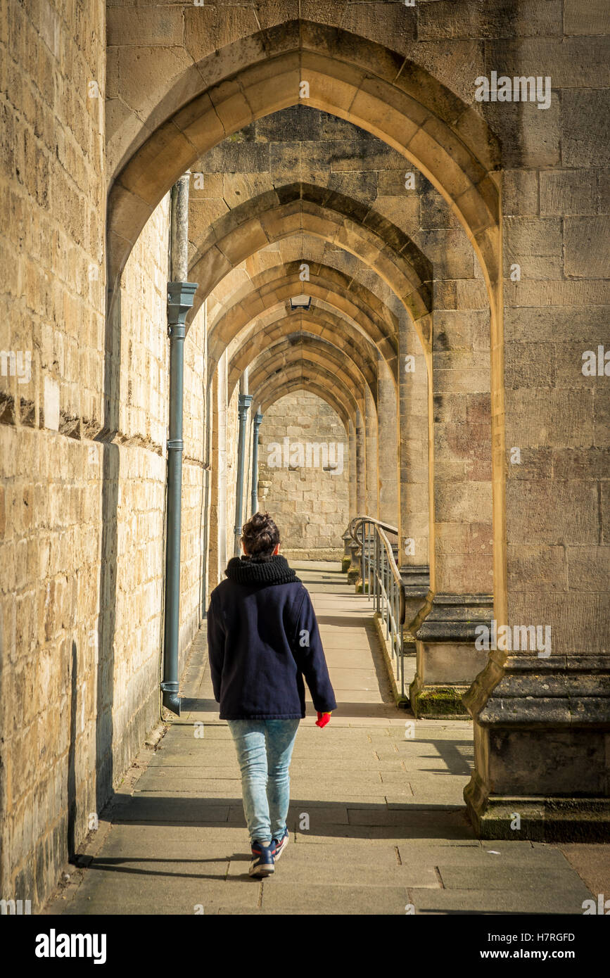 Pedestrian walking by Winchester Cathedral; Winchester, Hampshire ...