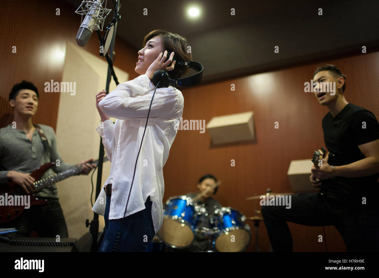 Chinese musical band in recording studio Stock Photo - Alamy