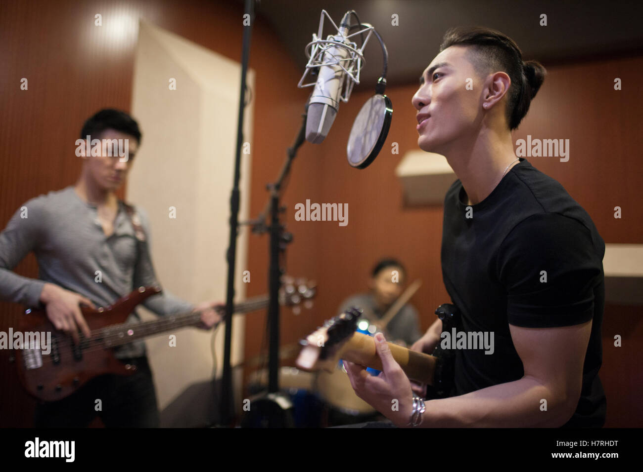 Chinese musical band in recording studio Stock Photo - Alamy