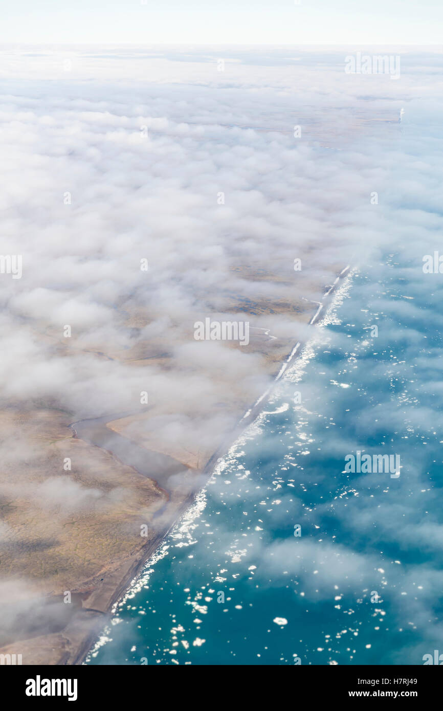 Aerial view of the North Slope coastline shrouded in a thin layer of ...