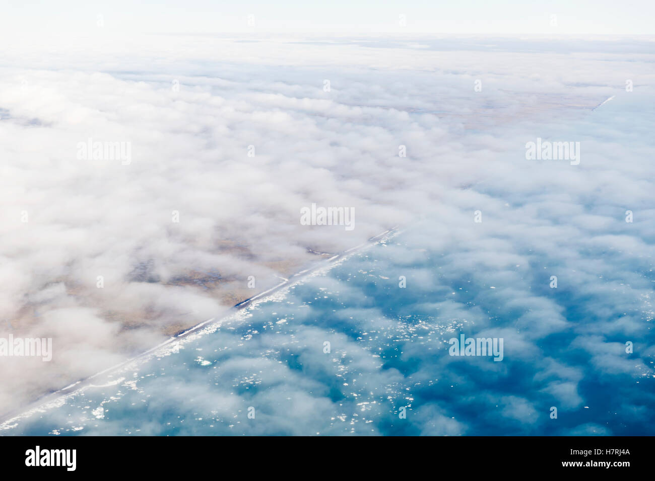 Aerial view of the North Slope coastline shrouded in a thin layer of ...