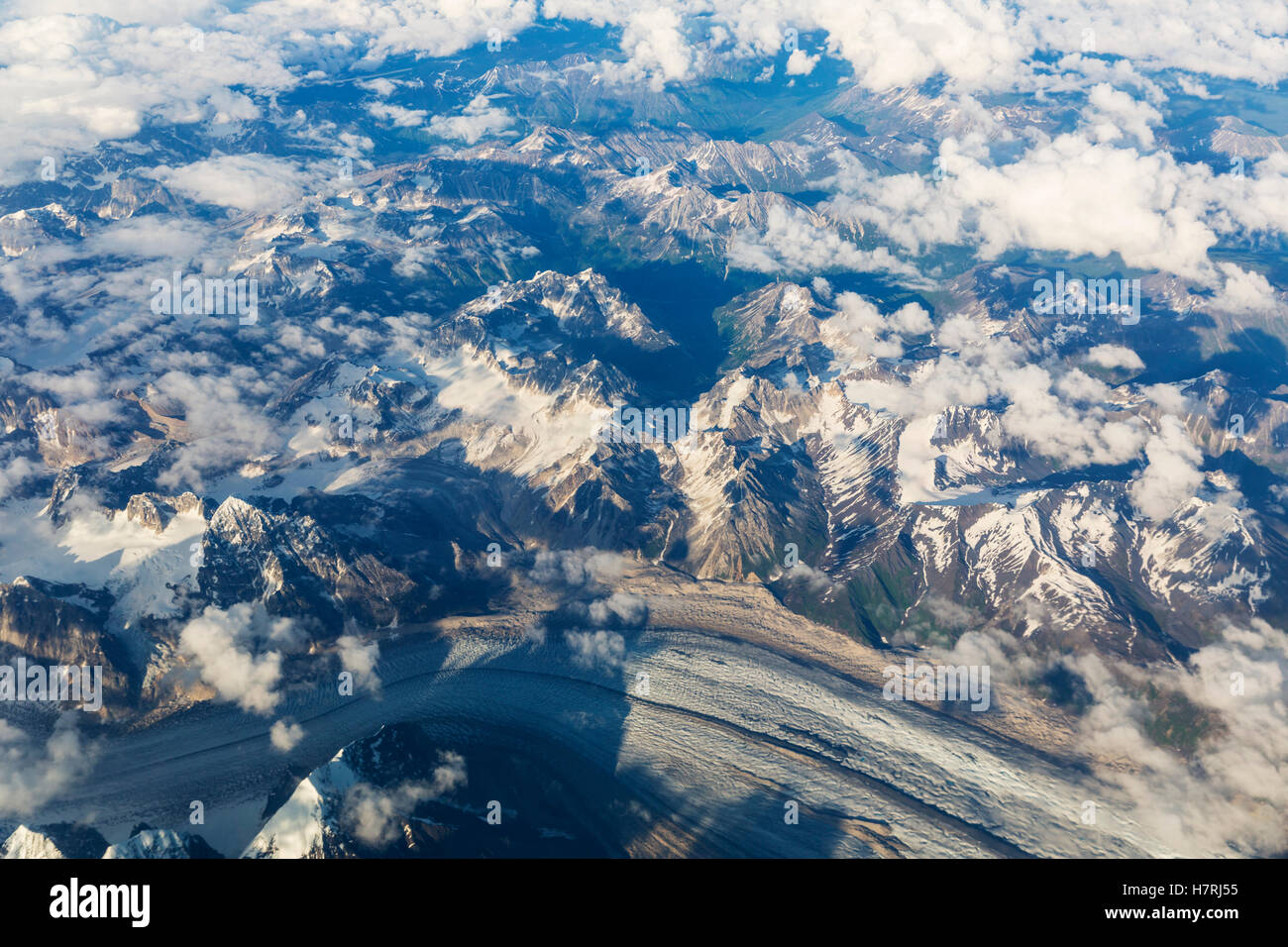 Aerial view of clouds twisting among the snowy peaks of the Alaska ...