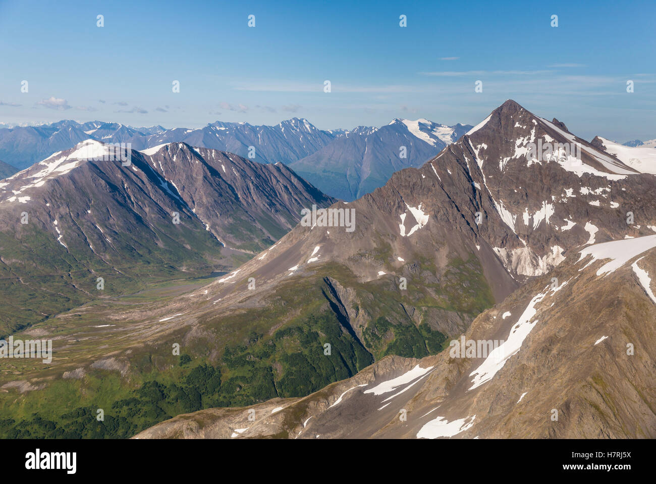 Aerial view of spring snow melting off the Kenai mountains on a clear summer day, Kenai ...