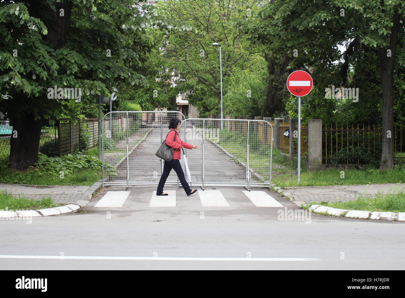 woman pass in the front of fence Stock Photo - Alamy