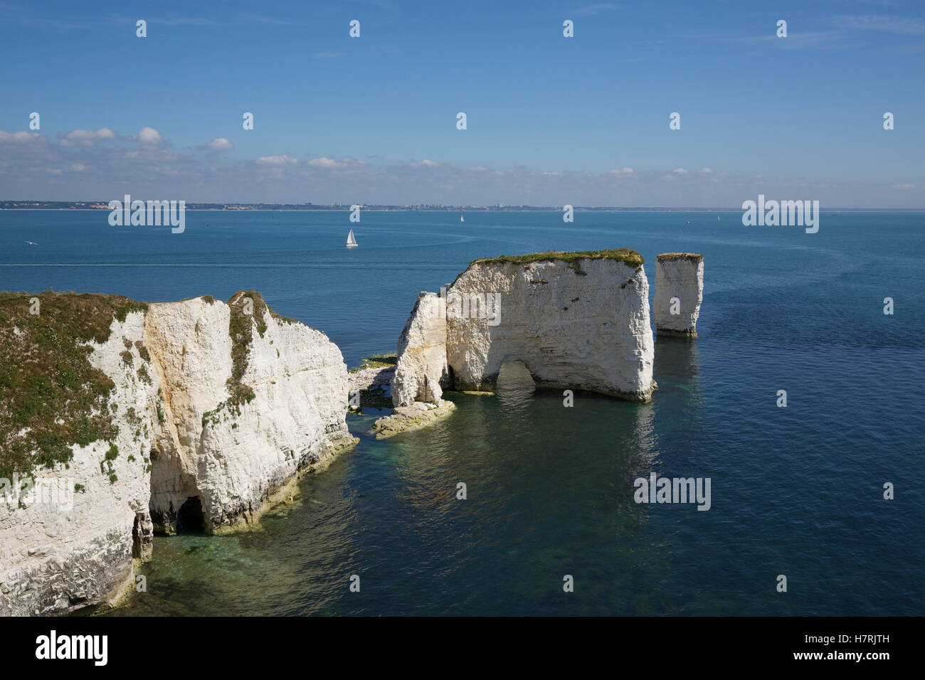Dramatic limestone cliffs and off shore stacks with archways and caves ...