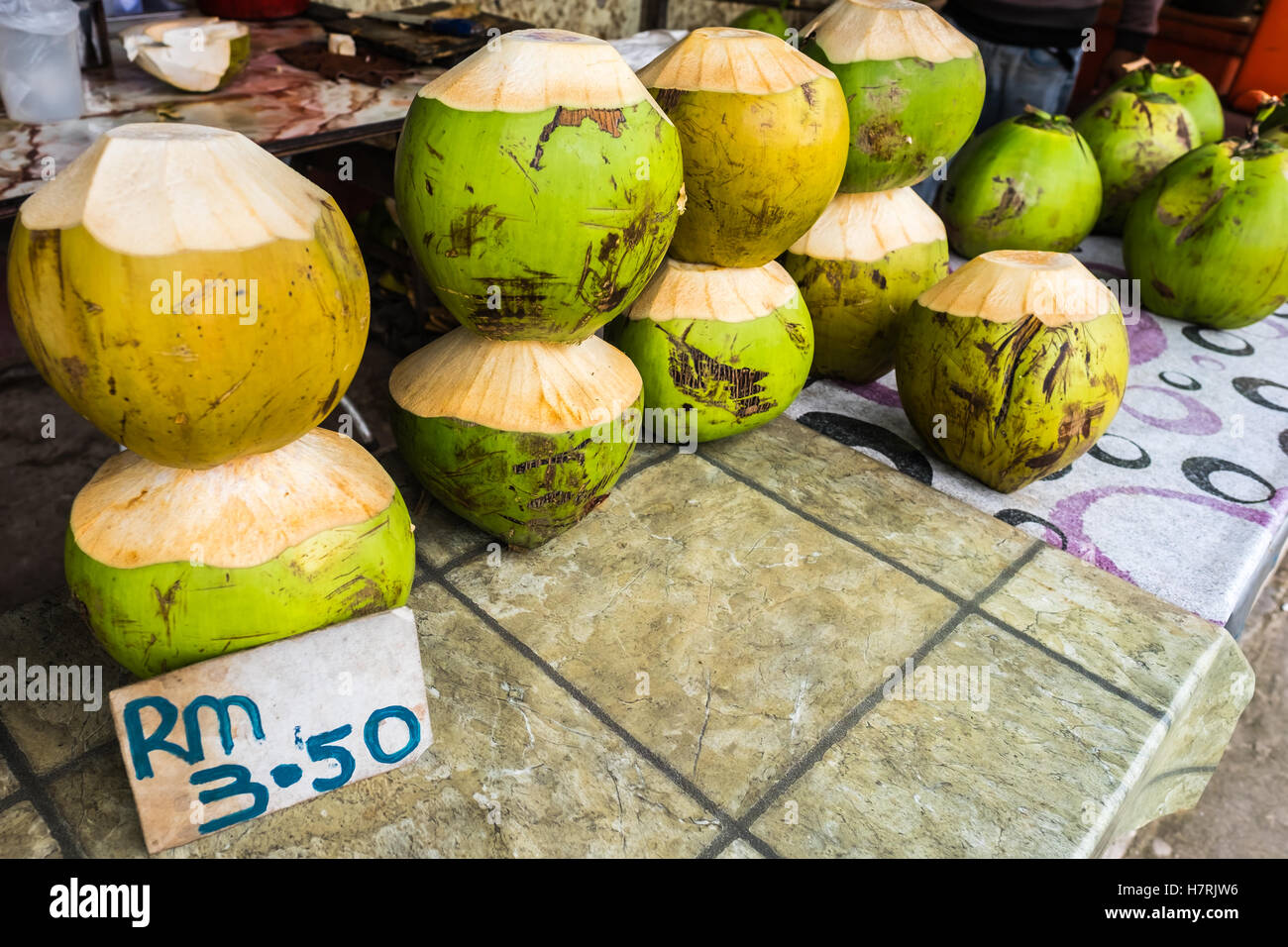 Fresh coconuts being sold at roadside stall in Borneo Stock Photo - Alamy