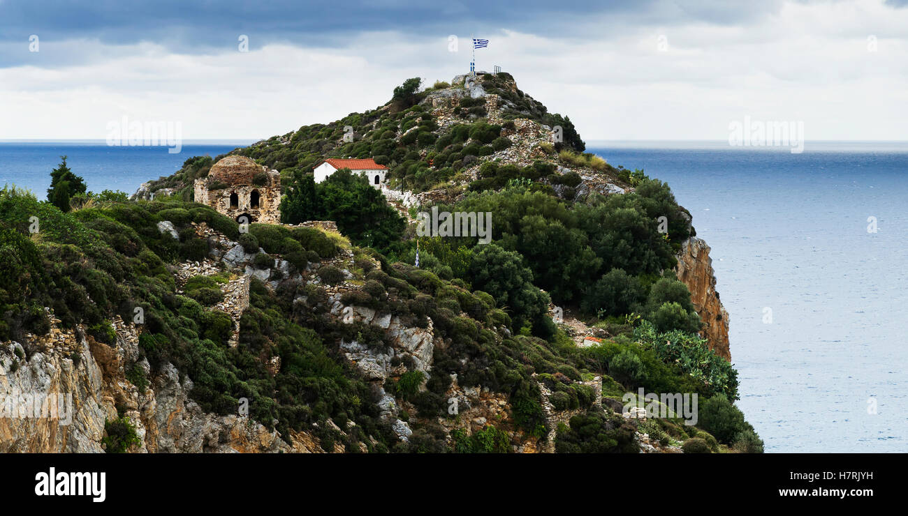 House and old building with greek flag on a rocky promontory along the ...