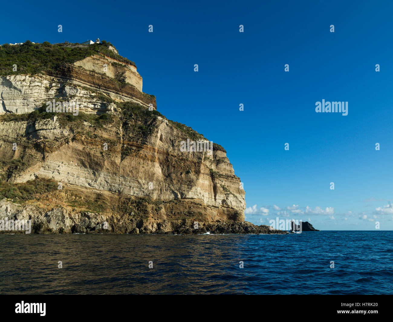 Tall rugged cliffs along the island of Ischia; Ischia, Campania, Italy ...