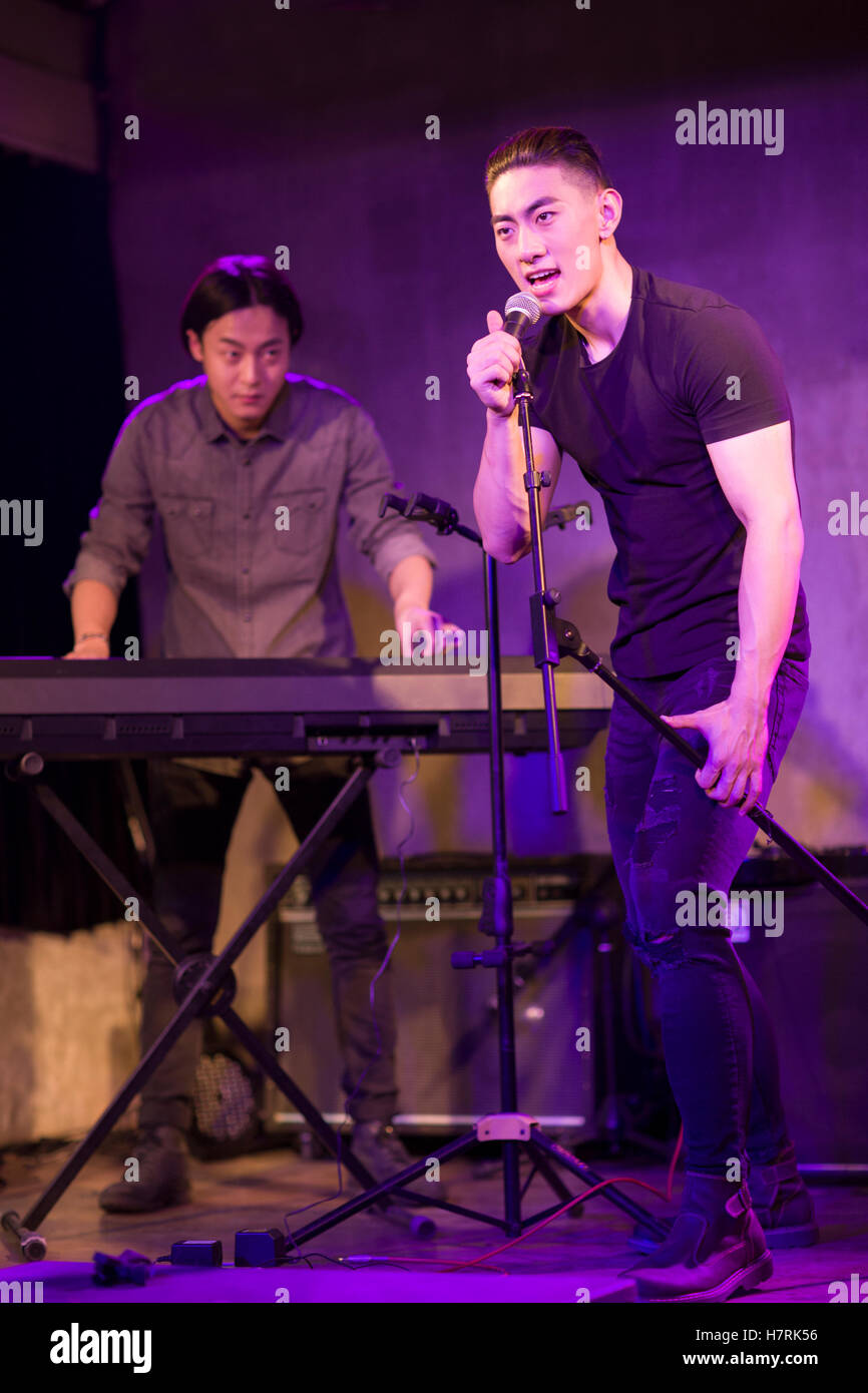 Young Chinese man singing on stage Stock Photo - Alamy