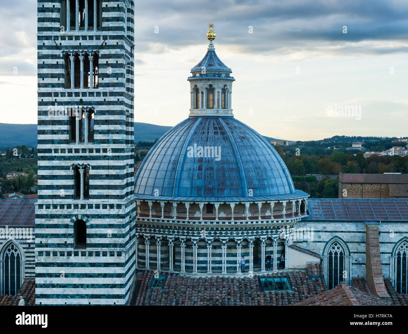Striped facade of a tower and dome roof of Siena Cathedral; Siena ...