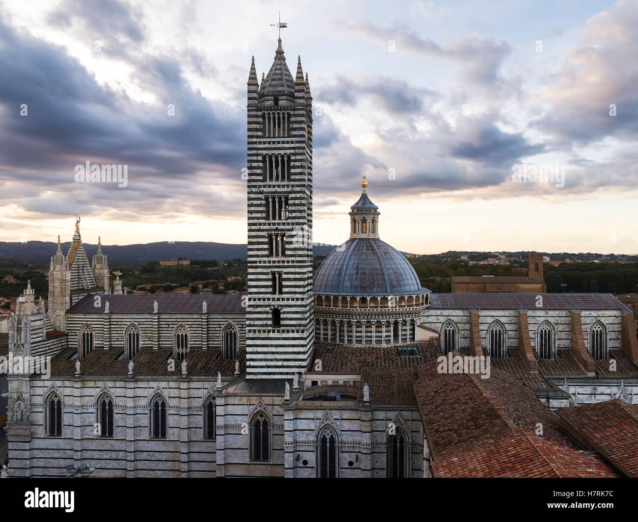 Striped facade of a tower and dome roof of Siena Cathedral; Siena ...