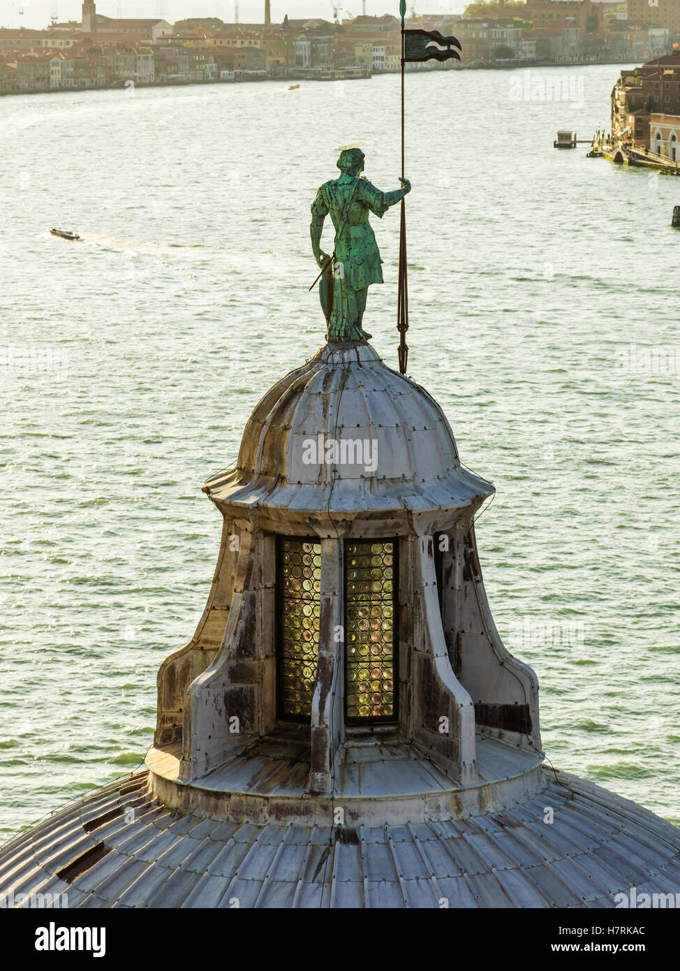 Green statue on top of a dome roof with view of a canal; Venice, Italy ...