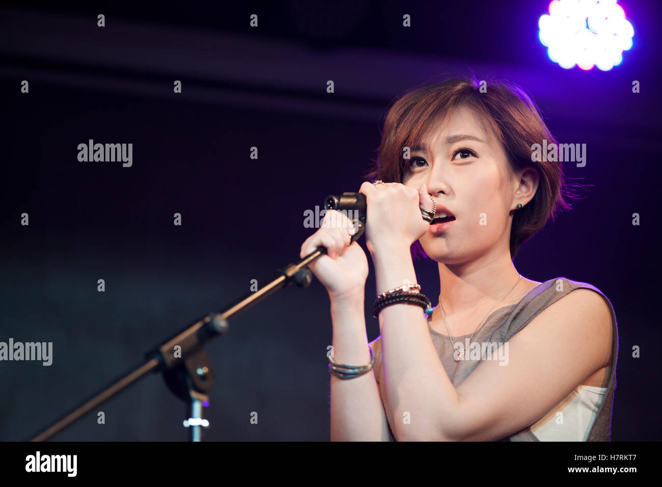 Young Chinese woman singing on stage Stock Photo - Alamy