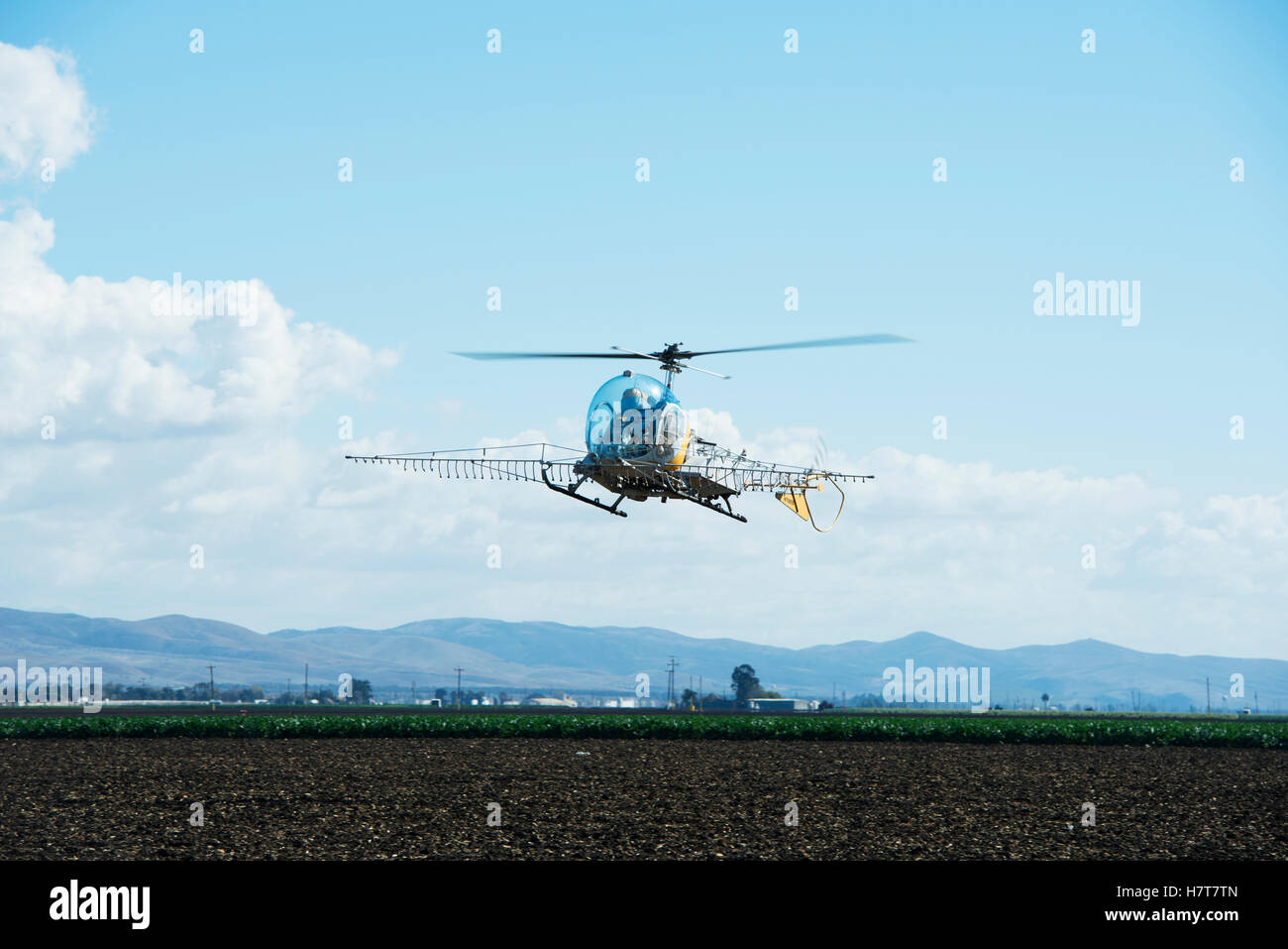 Helicopter landing to refill spray tanks; Gonzales, California, United ...