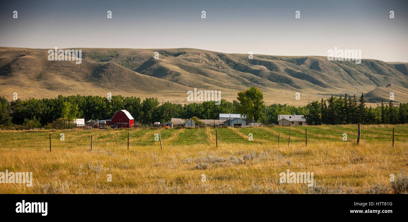 Prairie farms with hills in the background; Saskatchewan, Canada Stock ...