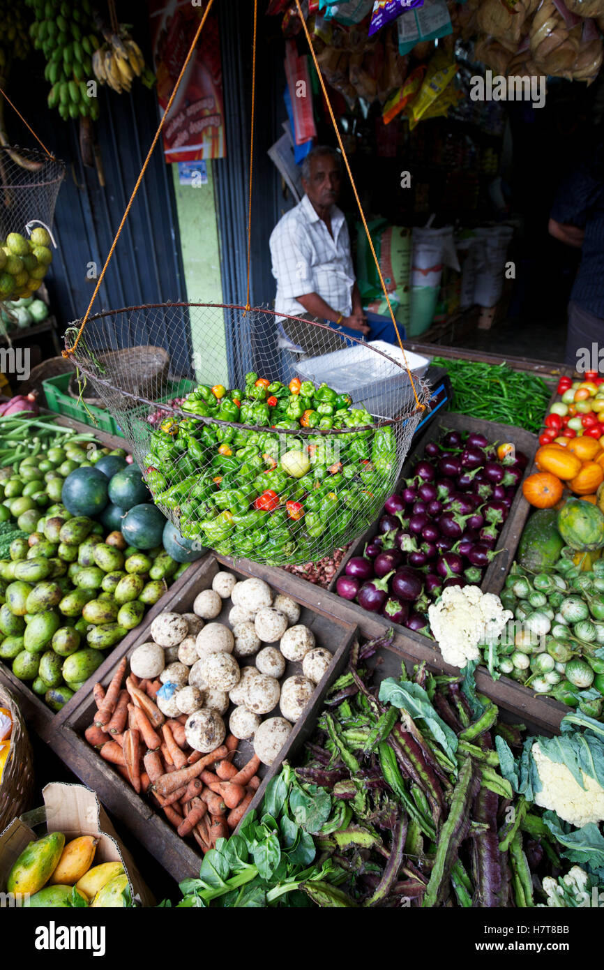 Traditionally dressed man selling vegetables on a street stall Stock ...