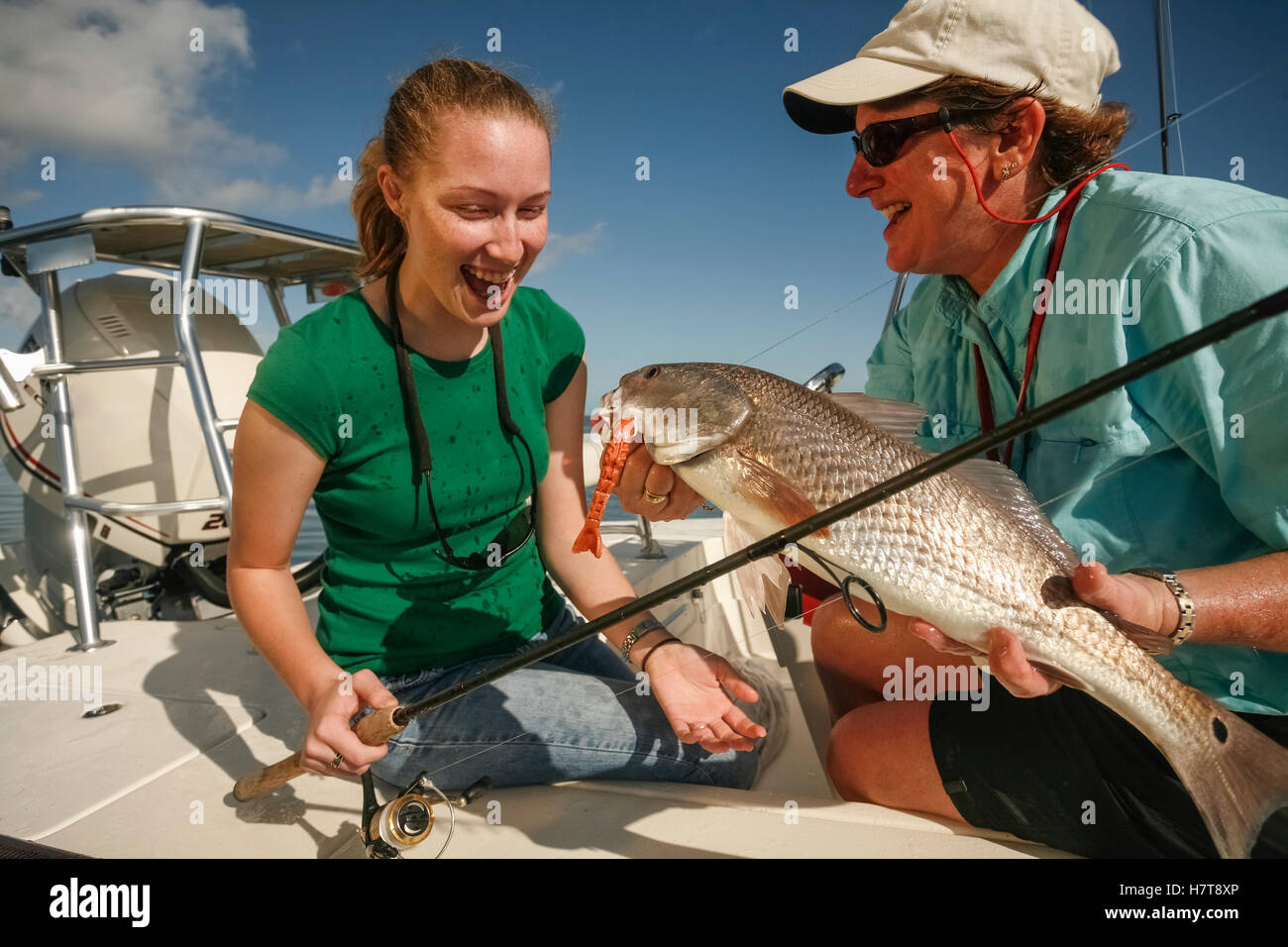 Woman Catches Redfish While Saltwater Fishing Stock Photo - Alamy