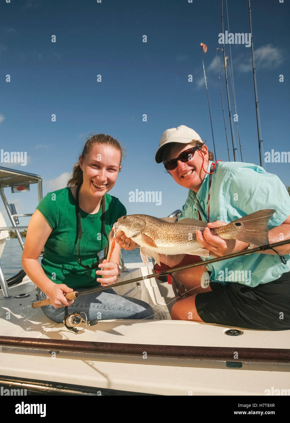 Woman Catches Redfish While Saltwater Fishing Stock Photo - Alamy