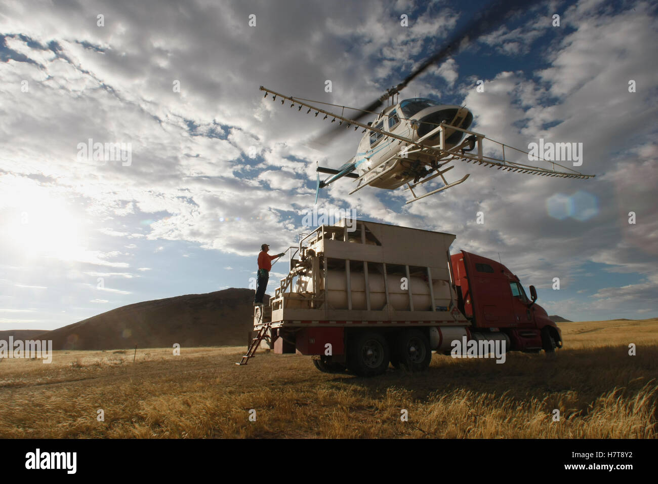 Chemical Spraying Helicopter Flies Over Chemical Storage Truck Stock ...