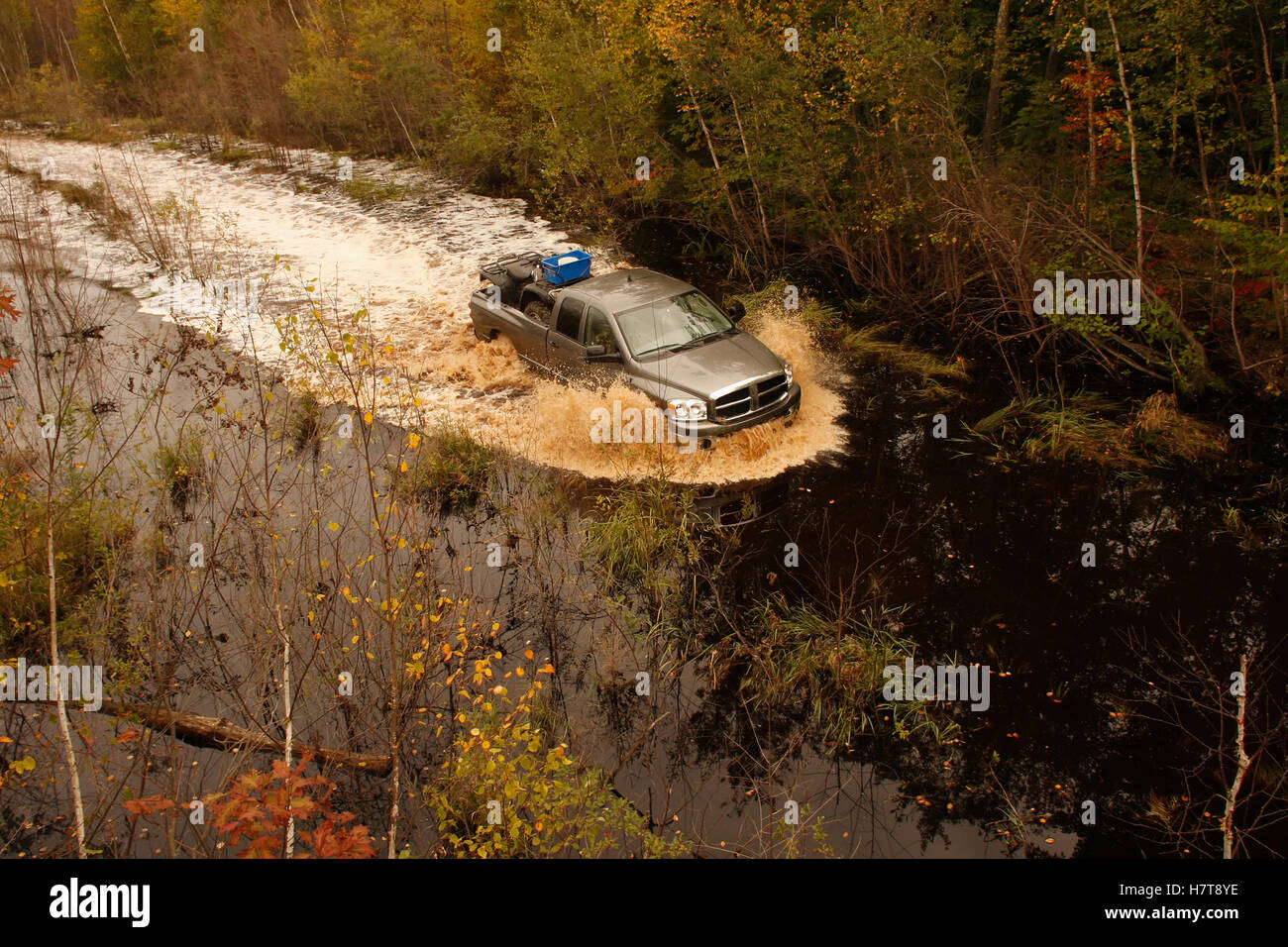 Pickup Truck Driving Through Water Hauling Atv Stock Photo - Alamy