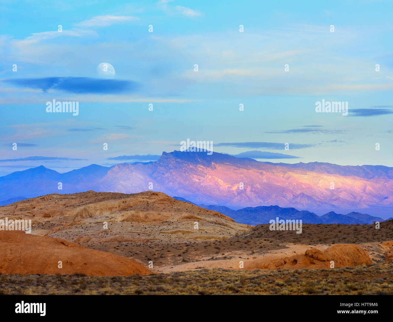Sunset lighting up mountains under a full moon in Valley of Fire State ...