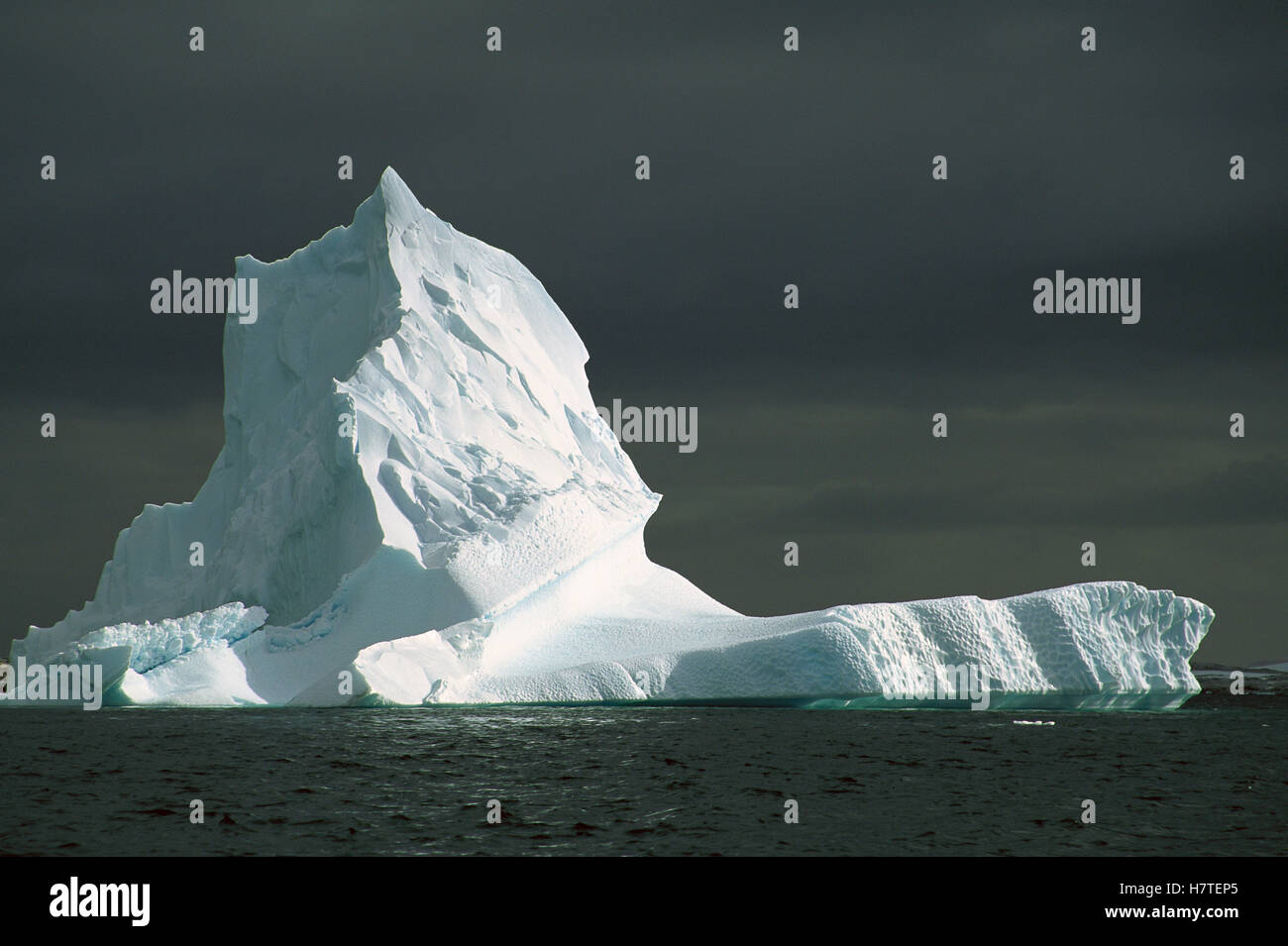 Grounded iceberg with storm clouds overhead, Pleneau Island, Antarctic ...