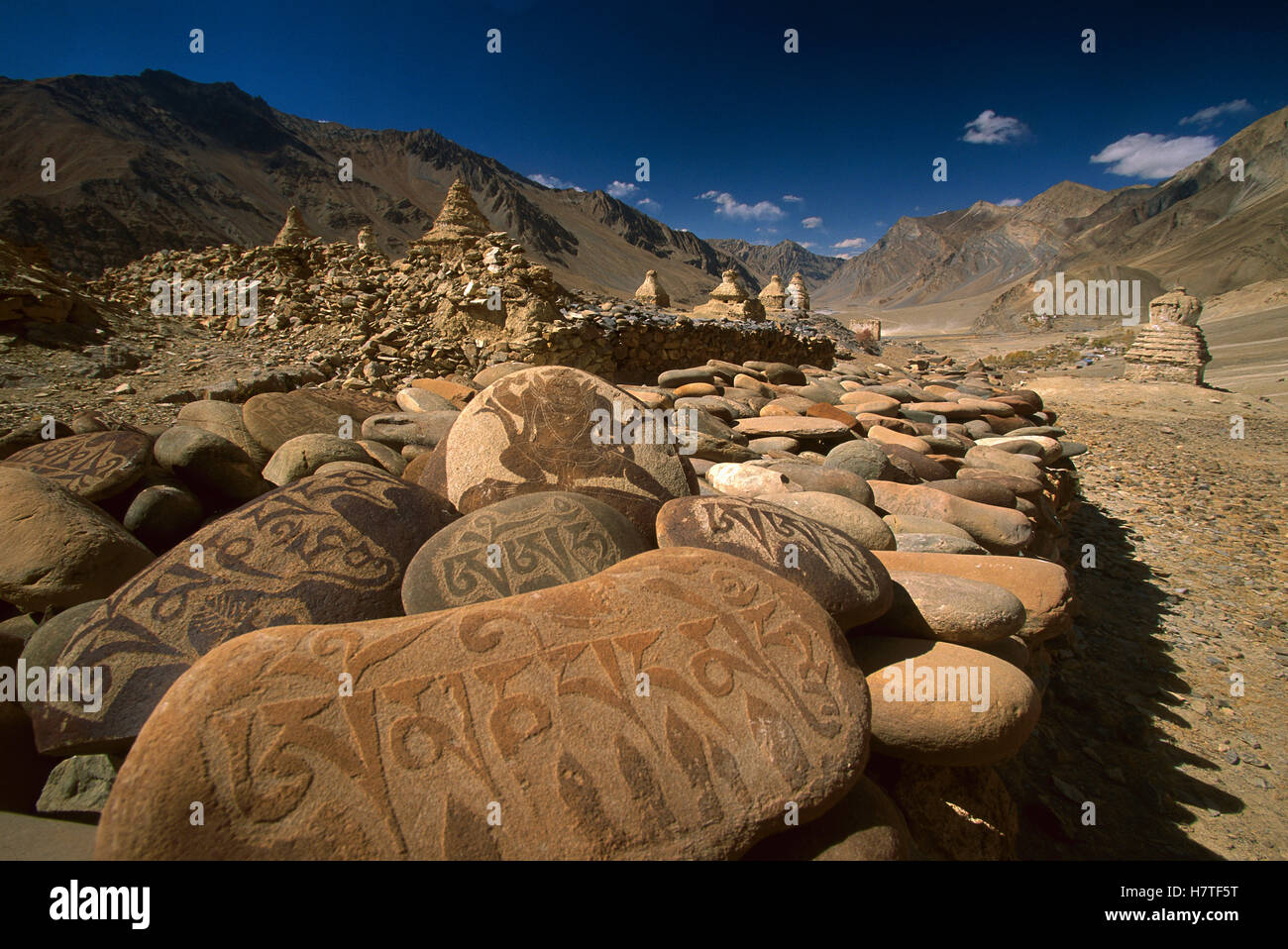 Carved Buddhist mani stones below ruined palace, Zangla, Kingdom of ...