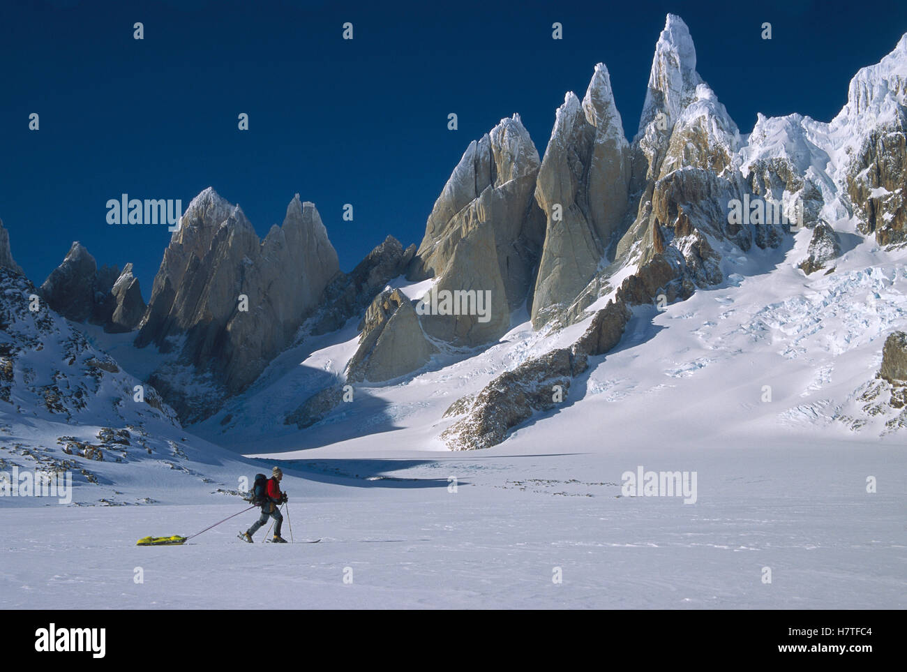 Skier pulling sledge near Cerro Torre, Los Glaciares National Park ...