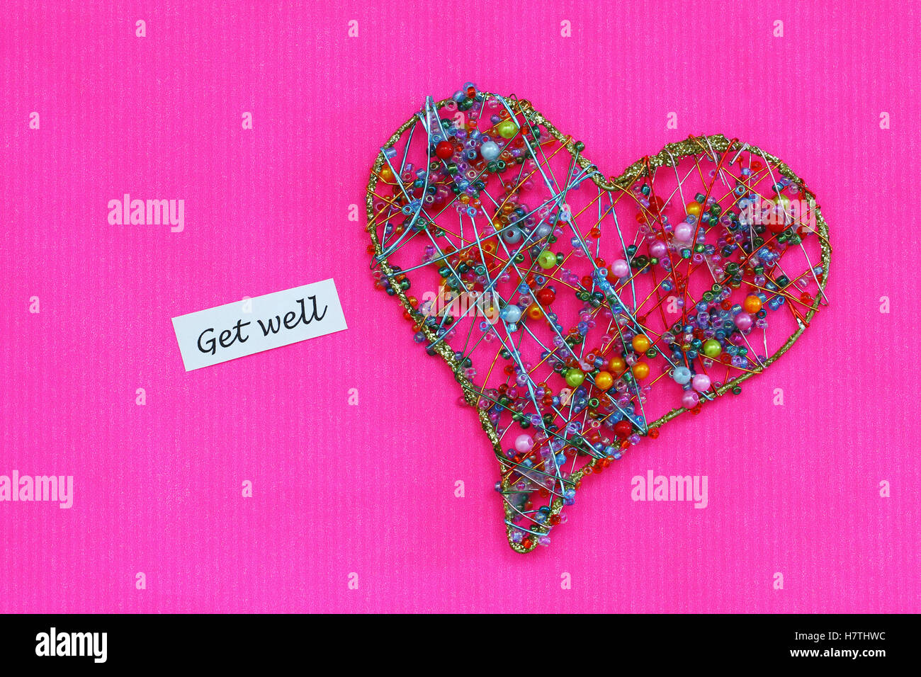 Get well card with heart made of colorful beads on pink surface Stock ...
