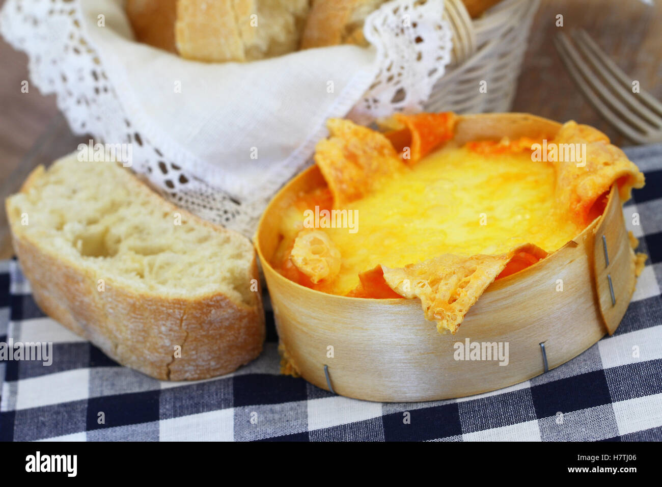 Baked cheese and ciabatta bread on blue and white checkered cloth Stock ...