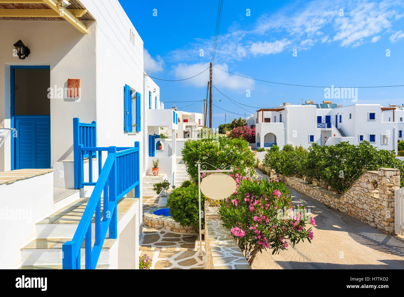 View of street with typical Greek houses in Naoussa town, Paros island ...