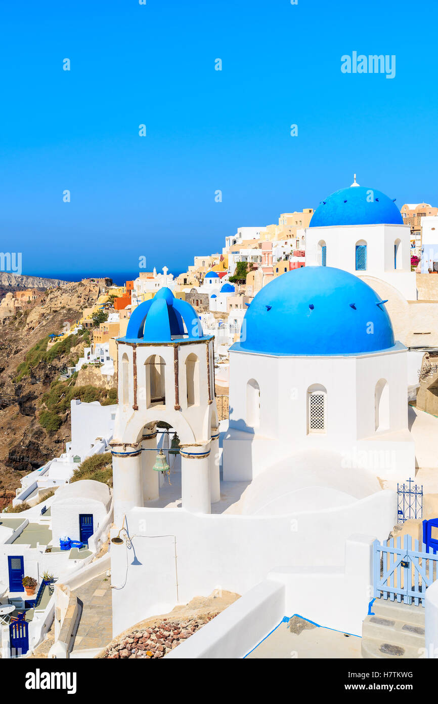 Famous blue domes of white churches in Oia village on Santorini island ...