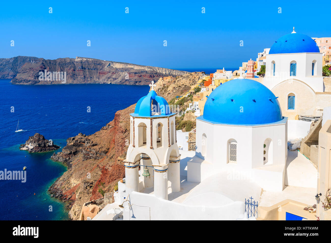 Famous blue domes of white churches in Oia village on Santorini island ...