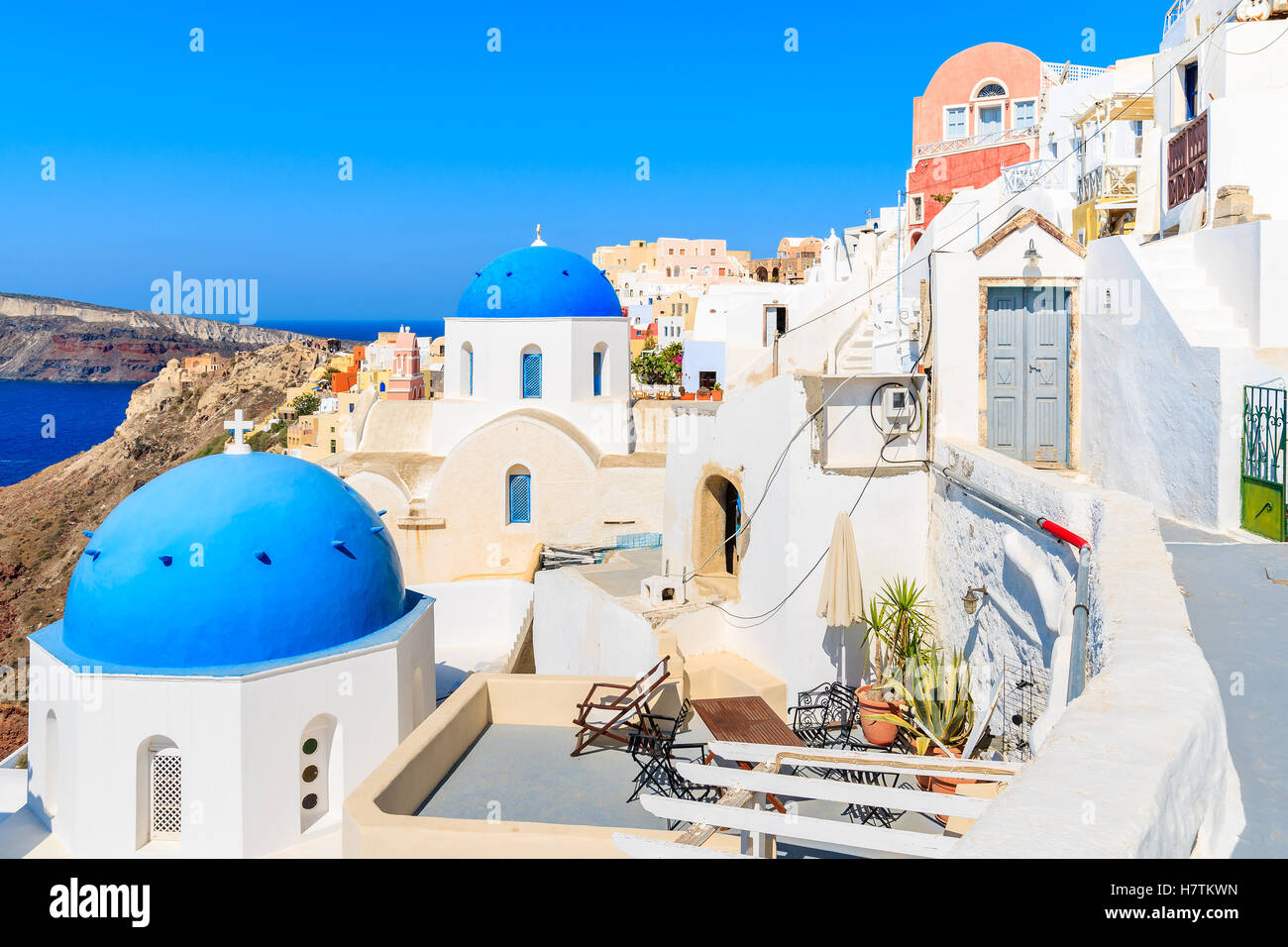 Famous blue domes of white churches in Oia village on Santorini island ...
