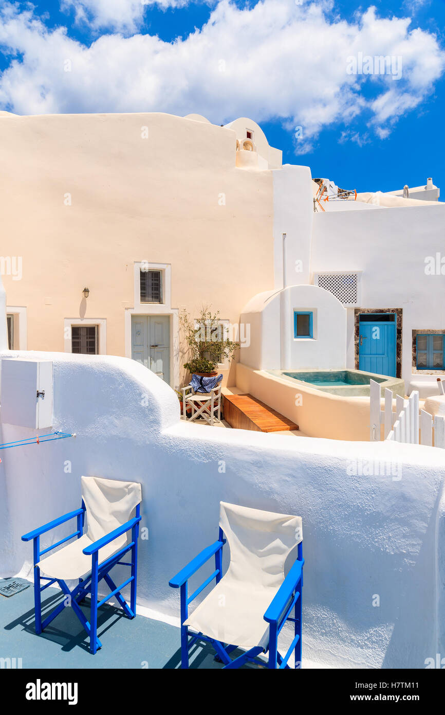 Chairs on terrace of typical Greek houses in Oia village on Santorini ...