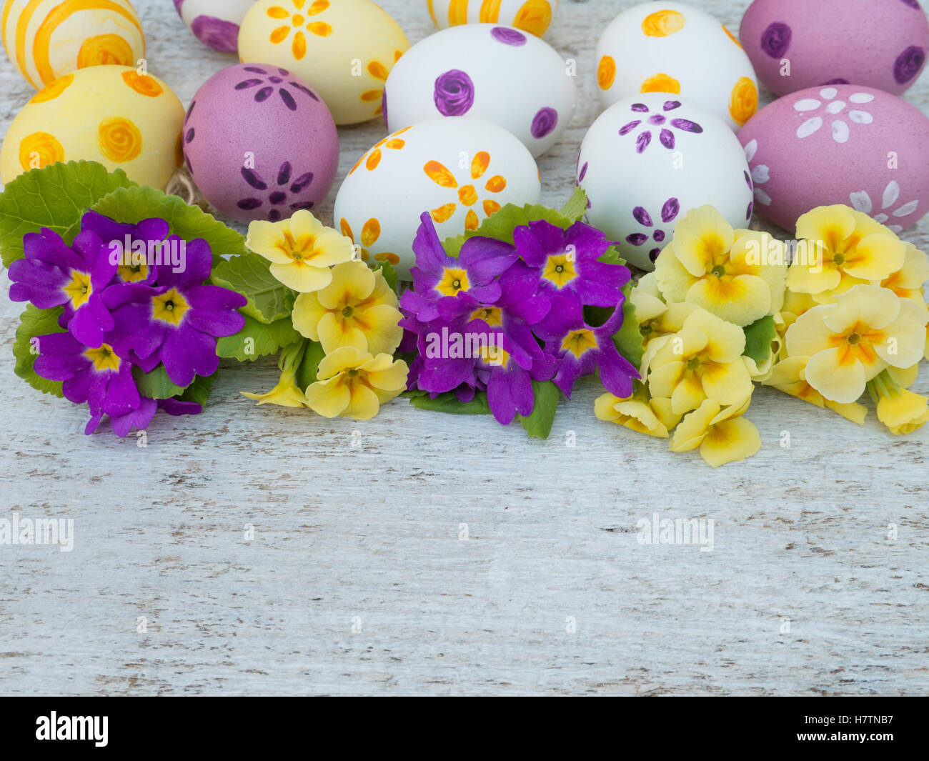 White, violet and yellow easter eggs decorated by stripes, dots and ...