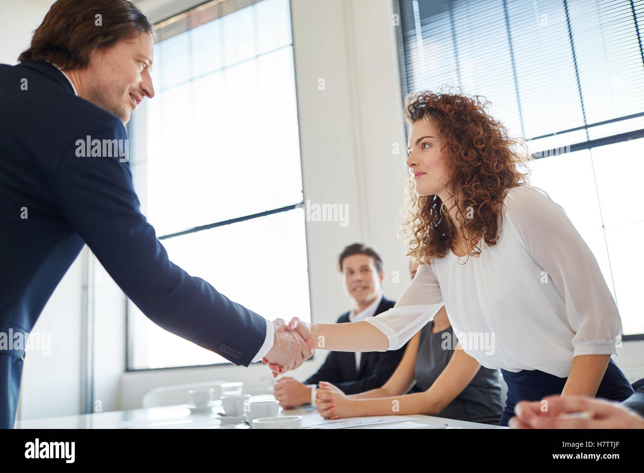 Business people shaking hands as partners in start-up Stock Photo - Alamy