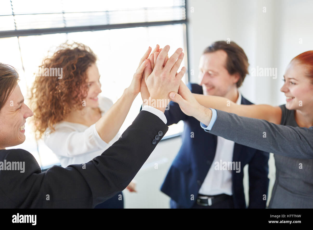 Successful team giving High Five in start-up meeting Stock Photo - Alamy