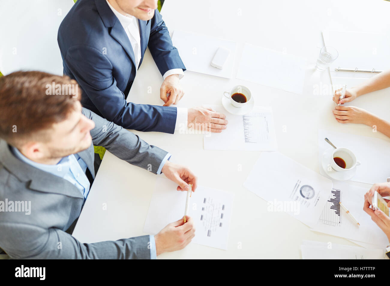 Start-up team in statistics analysis meeting Stock Photo - Alamy