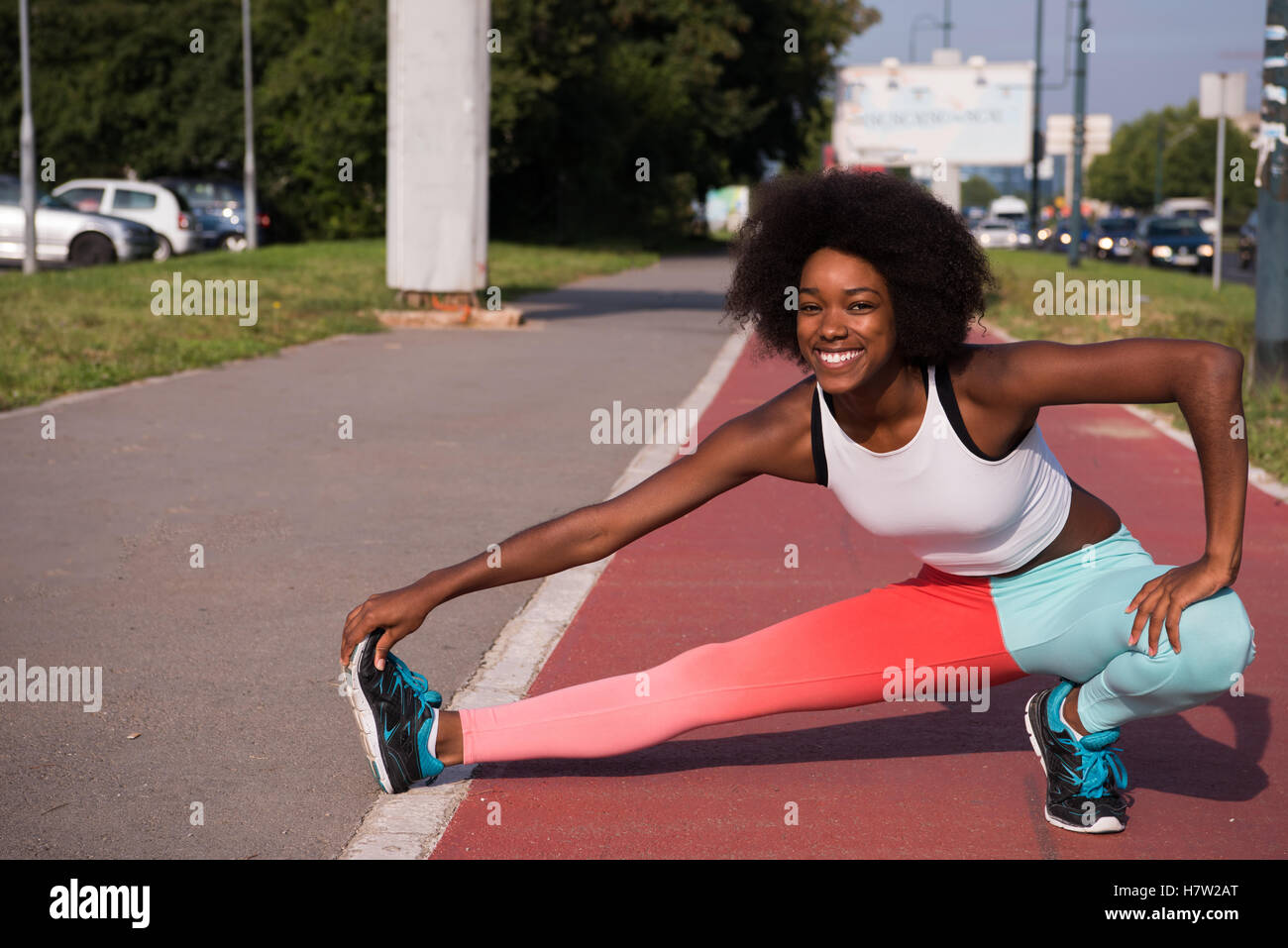 portrait of a young beautiful African American girl doing stretching ...