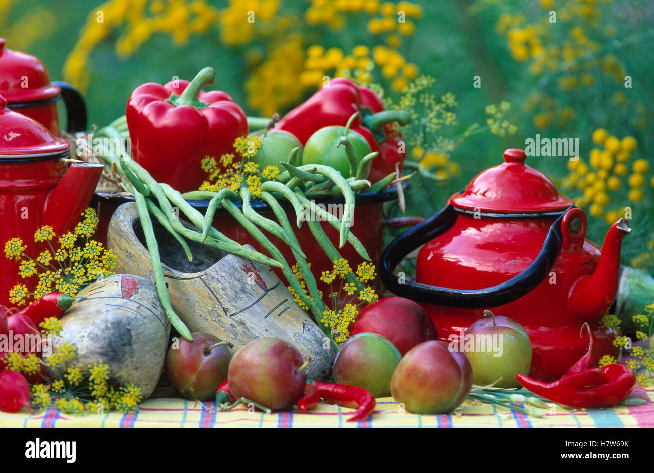 Still-life of red fruits and vegetables, clogs, and green beans Stock ...
