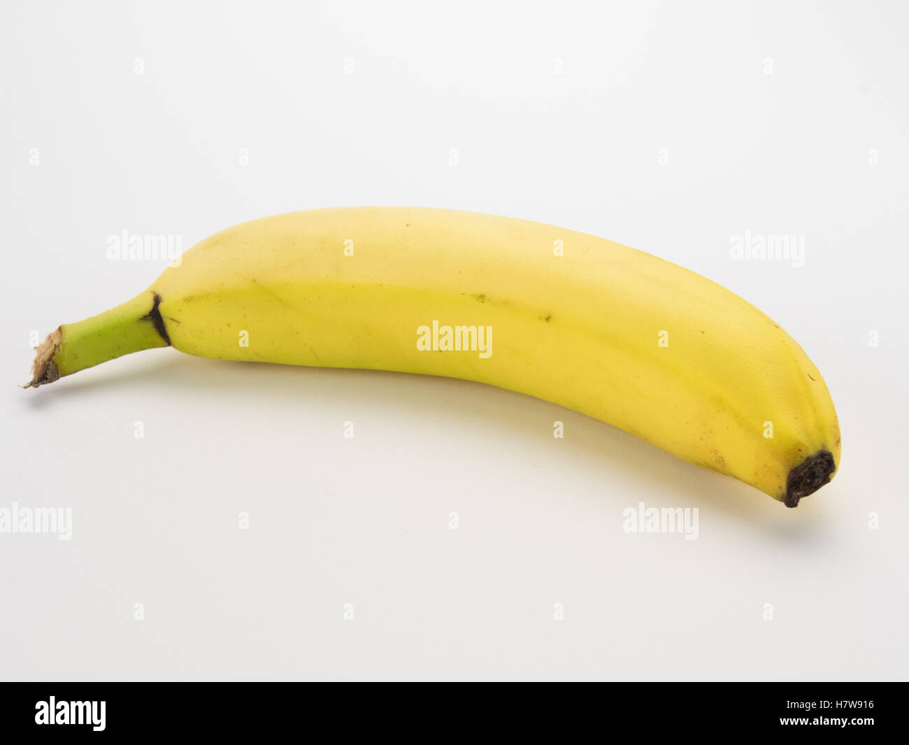 Banana on its side isolated on white Stock Photo - Alamy